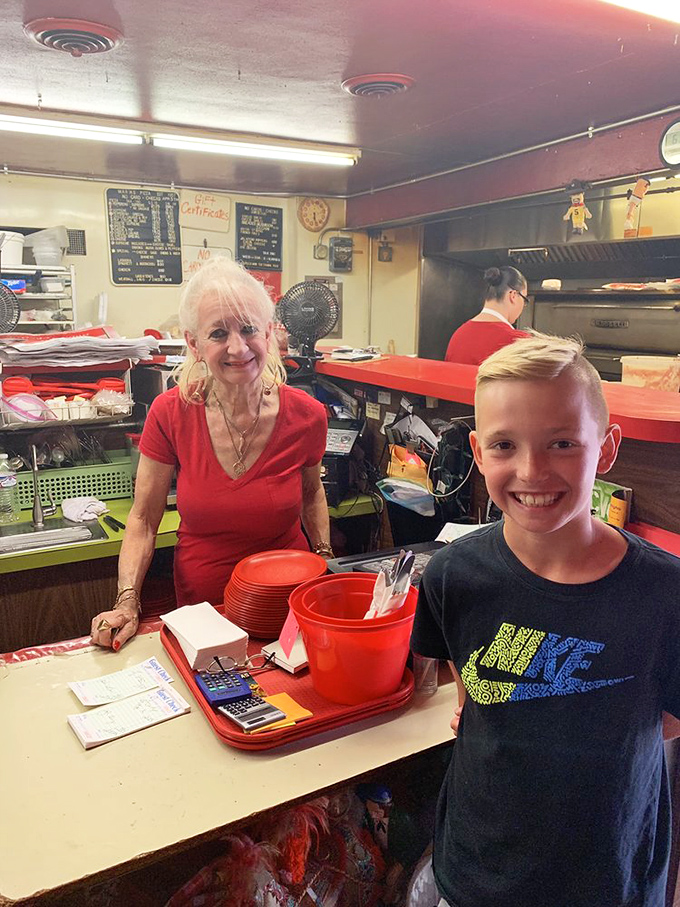 Behind the counter magic! The friendly faces of Maria's staff are the secret ingredient that makes every pizza taste like it's made with love.
