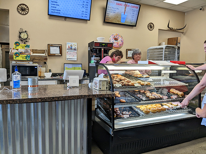 The donut dream team at work! These friendly faces are the unsung heroes behind your morning sugar fix.