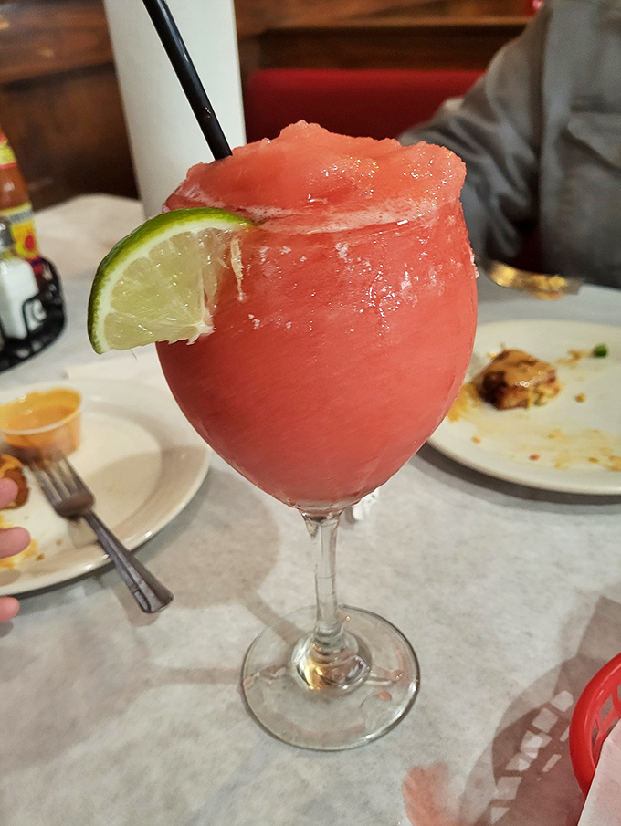 A strawberry sunset in a glass! This frosty margarita is the perfect way to cool down after wrestling with crab legs.