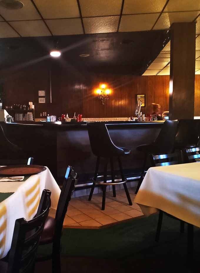 The bar area whispers of decades of stories shared over cold drinks and hot sandwiches in this Pittsburgh-area institution.