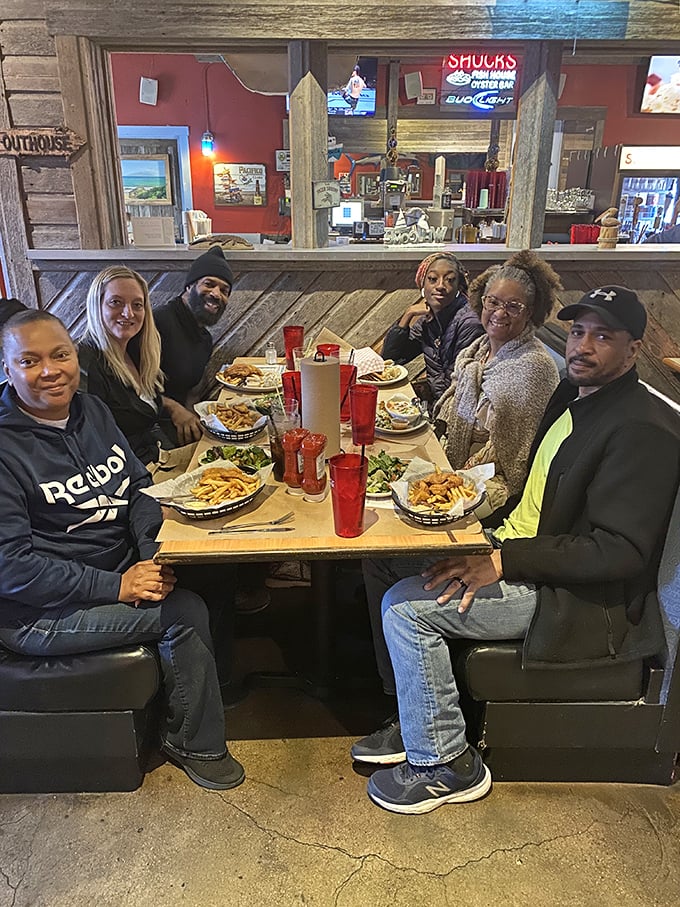 A feast fit for Poseidon himself! This merry crew of diners is diving into seafood delights with more gusto than pirates raiding a treasure chest.