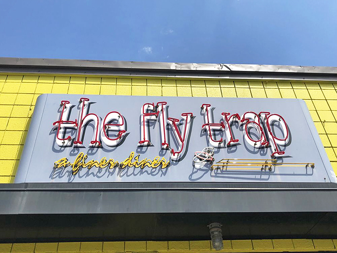 The Fly Trap: where neon dreams and breakfast schemes collide. It's not just a sign, it's a beacon of hope for hungry souls.