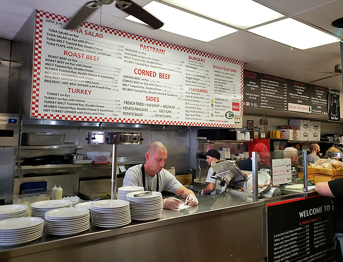 Behind the counter magic! Slyman's staff are sandwich sculptors, crafting edible masterpieces with the precision of Michelangelo (if he worked in corned beef).