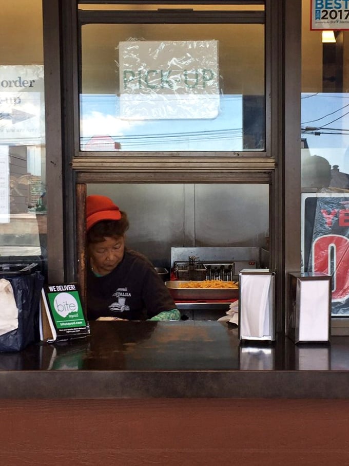 Behind the scenes magic! This kitchen wizard is crafting edible joy, one sizzling patty at a time.