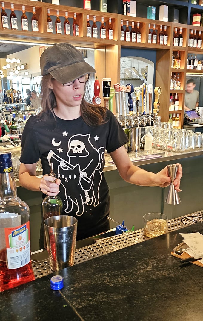 This bartender's shirt is spookier than my bank account after a night out. But hey, at least the drinks are flowing!