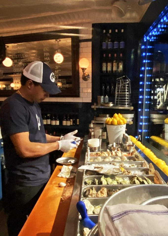 Oyster artistry at work: Watch as skilled hands transform briny bivalves into edible masterpieces. It's like "Top Chef" meets "The Little Mermaid."