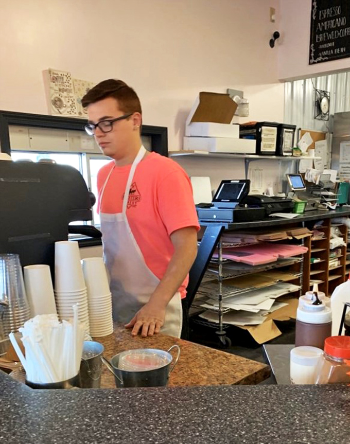 The wizard behind the curtain! This dedicated staff member is hard at work, ensuring your sugar fix is nothing short of magical.