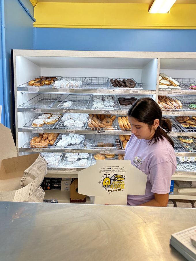 Behind the scenes of deliciousness! The staff works their magic, turning simple ingredients into rings of joy.