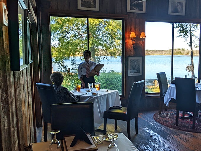 Service with a smile and a view to match. This waiter isn't just serving food, he's delivering happiness on a plate with a side of Southern charm.
