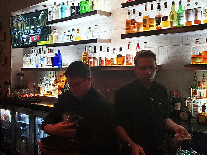 Masters of mixology at work! These bartenders craft drinks with the precision of a Swiss watchmaker and the flair of a Vegas magician.