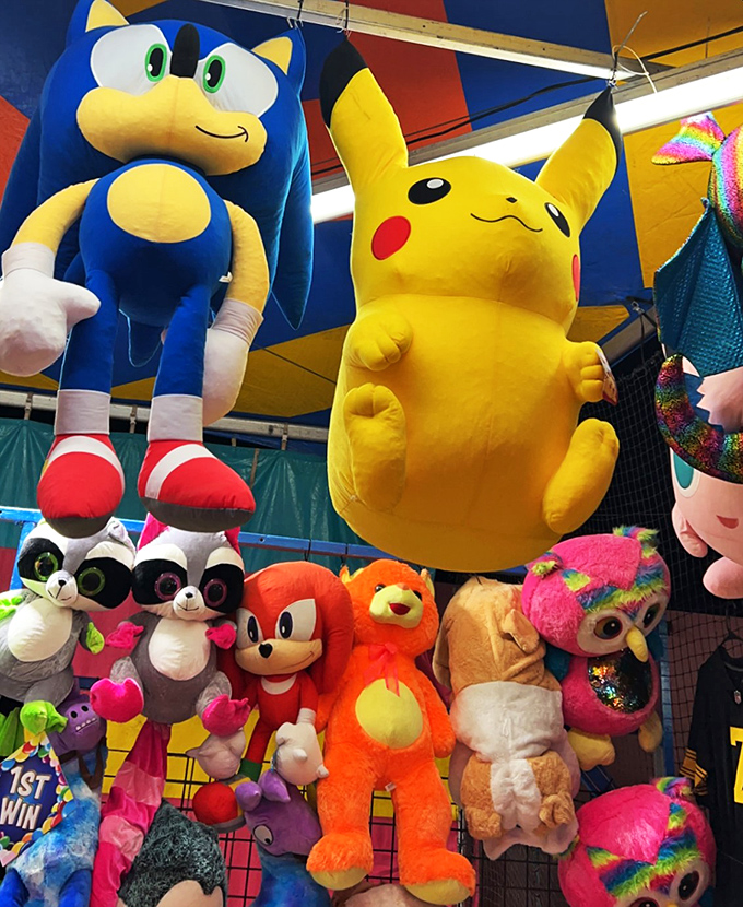 Plush pals from pixels to pocket monsters – this booth is like a hug factory for the young and young at heart.