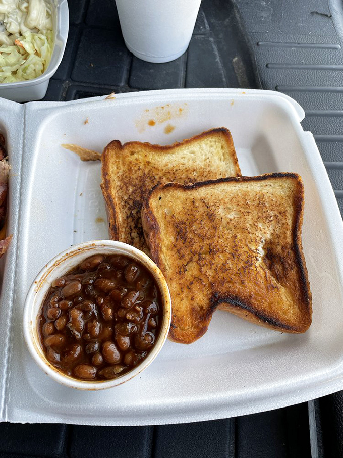 Golden Texas toast and saucy beans: the unsung heroes of barbecue. They're like the backup singers who steal the show with their harmonious flavors.