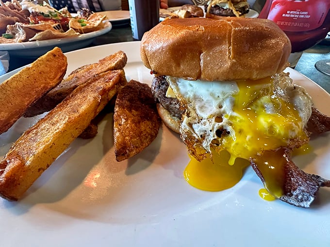 Burger alert! This bad boy is stacked higher than your to-do list, but infinitely more enjoyable. The fries? They're not just sidekicks; they're co-stars.