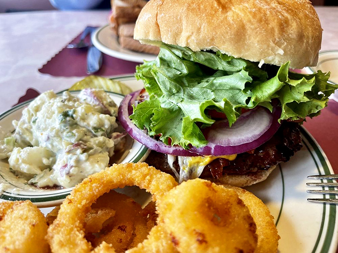 Hold onto your napkins, folks! This burger is stacked higher than a Jenga tower and twice as likely to make you say "Oh yeah!"