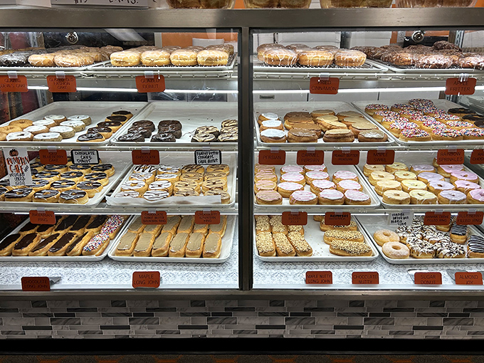 Feast your eyes on this glass case of emotion! From classic rings to fancy long johns, this display is like a museum of edible art. Michelangelo, eat your heart out (or these donuts).