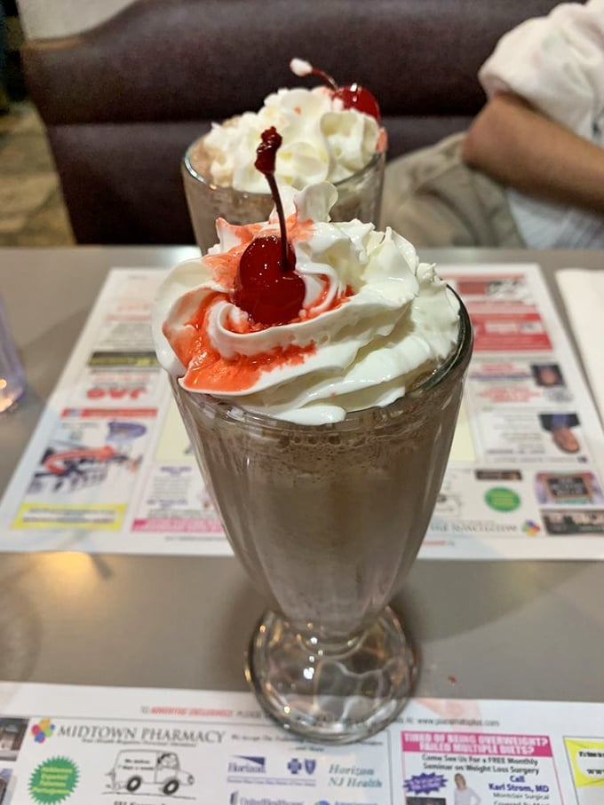 Shake it up, baby! This towering treat isn't just a milkshake; it's a dessert skyscraper with a cherry on top.