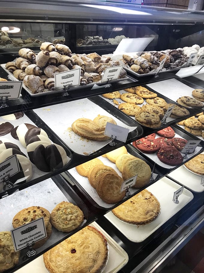 A pastry case that would make Marie Antoinette say, "Let them eat everything!" Sweet temptations as far as the eye can see.
