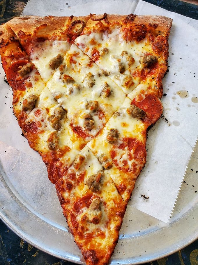 Pizza perfection, one slice at a time! This sausage and pepperoni masterpiece is what cheesy dreams are made of.