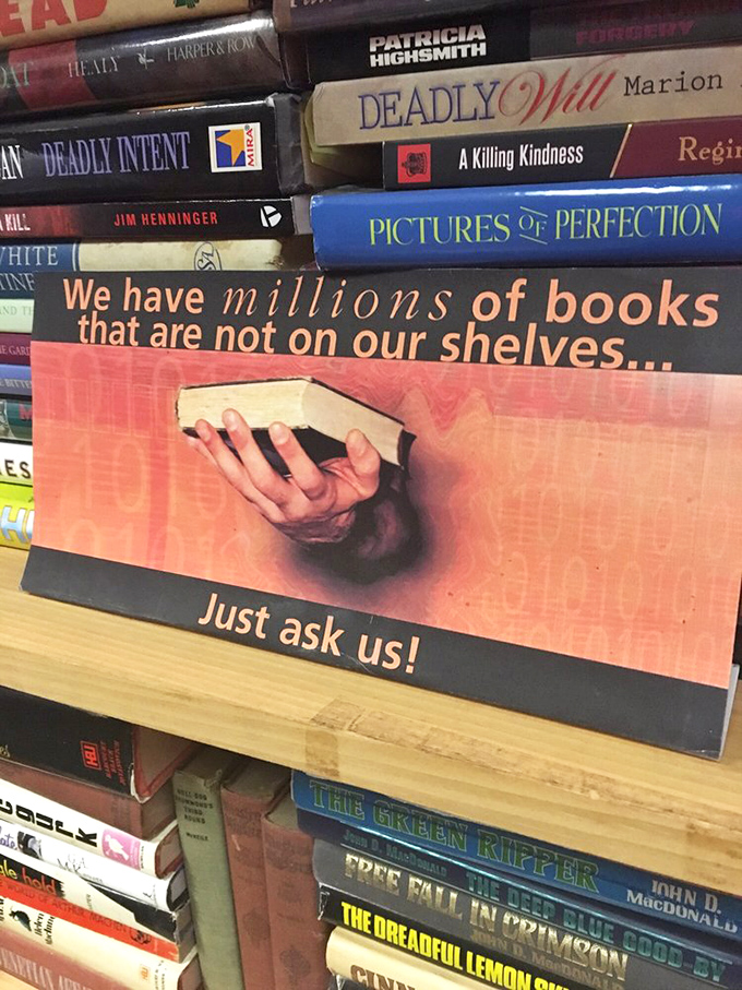 "Millions of books not on our shelves." Challenge accepted! This sign is the bibliophile's version of "Hold my beer."