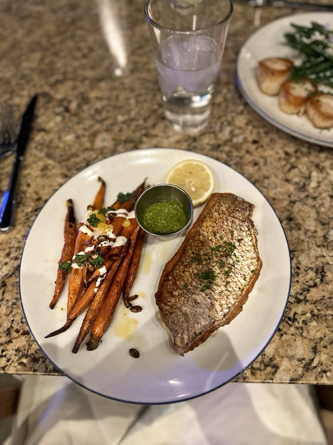 Fish so fresh, it might start swimming! This yellowtail snapper and roasted carrots duo is a plate of pure coastal bliss.