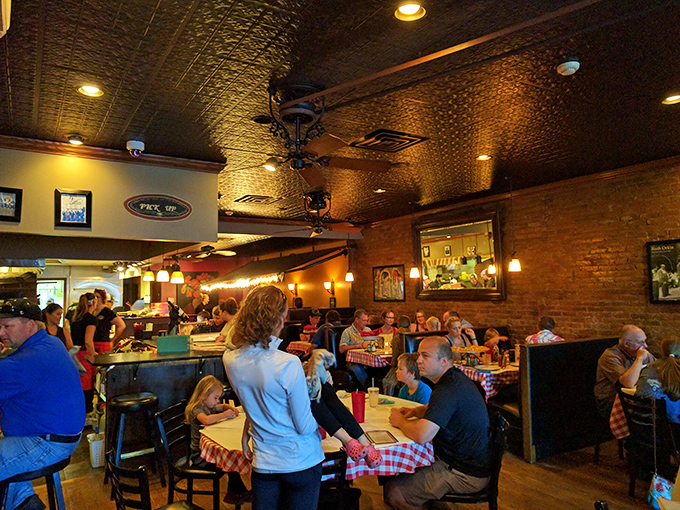 Happy faces and full plates! Diners dive into their pizzas with the enthusiasm of kids on Christmas morning.