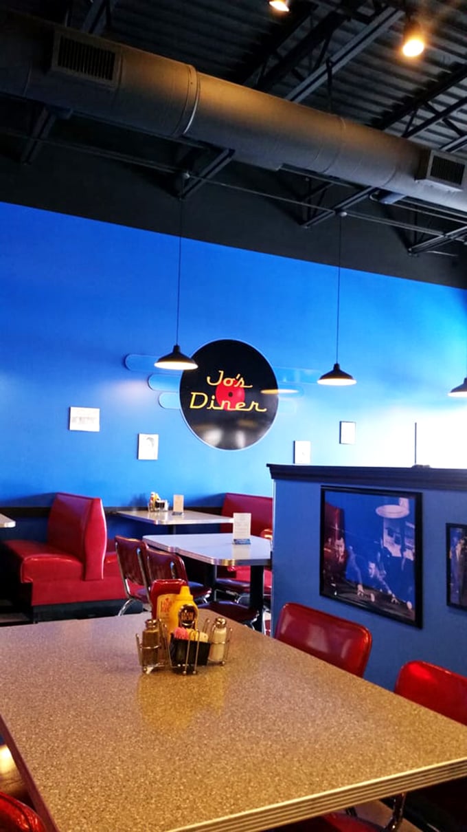The vibrant blue walls and red booths create a dining space that feels both retro and fresh&mdash;like the 1950s got a modern makeover.