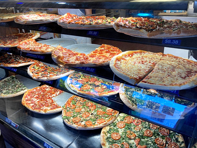 Pizza perfection on display! This case is like a museum of mouthwatering masterpieces, each one begging to be devoured.