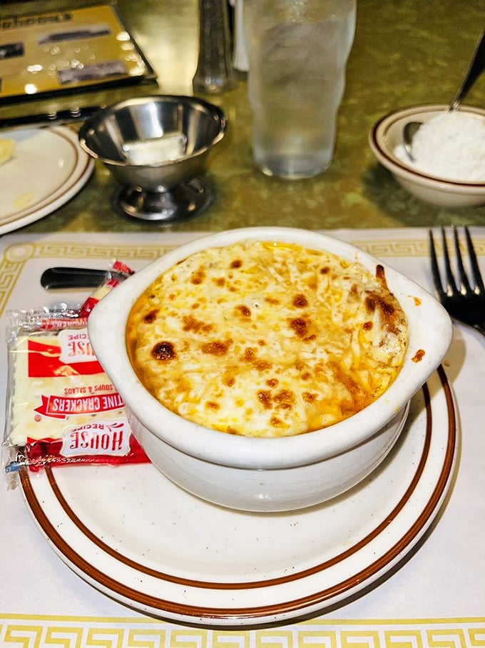 Behold the French Onion Soup, a cheesy volcano of flavor. It's not just soup; it's a warm, gooey hug for your taste buds.