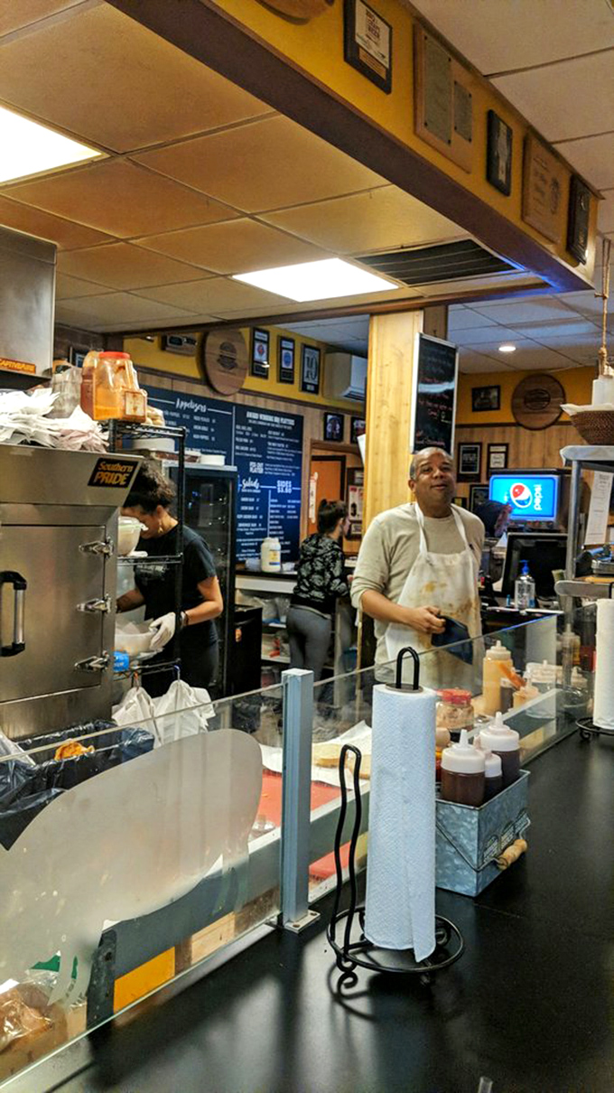 Where smoke meets science in an open kitchen ballet. The kitchen crew works with the practiced precision of pit masters who know their craft.
