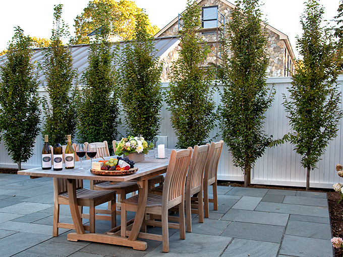 Dine al fresco in New England style. This charming outdoor setup is perfect for sipping wine and watching the world go by.