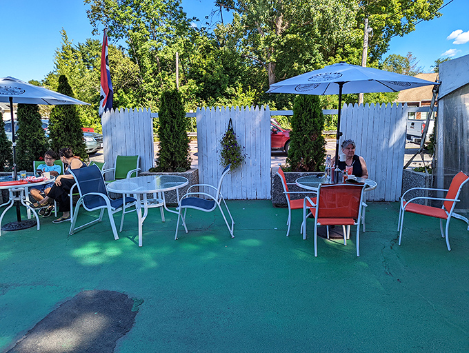 The outdoor seating area offers fresh air with your fresh coffee, a green oasis for those who prefer their eggs with a side of sunshine.