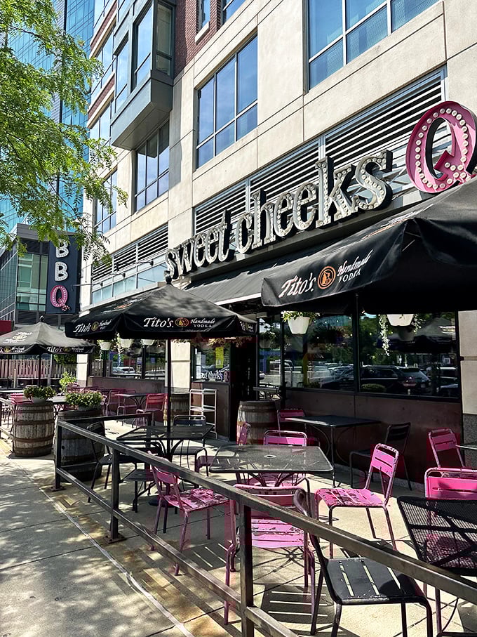 Pink chairs on the patio create an optimistic backdrop for summertime feasting, where barbecue and people-watching form a perfect Fenway afternoon.