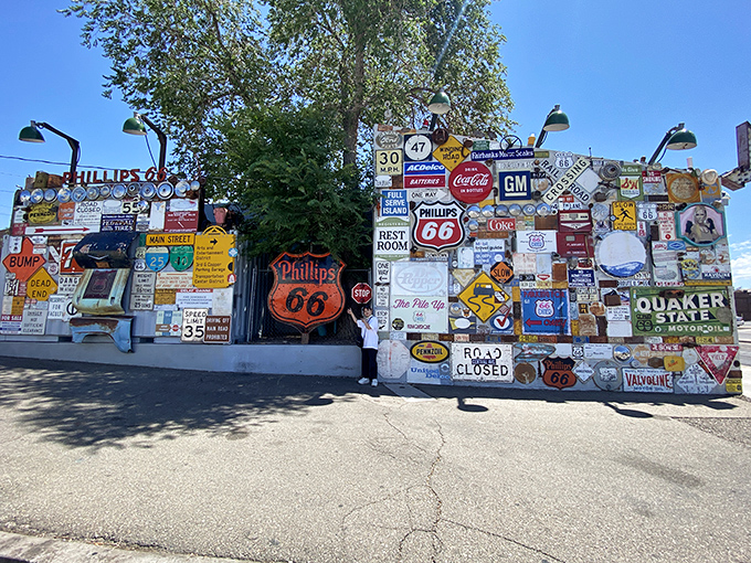 Talk about leaving your mark! This wall of vintage signs is like a road trip across America, minus the "are we there yet?" moments.