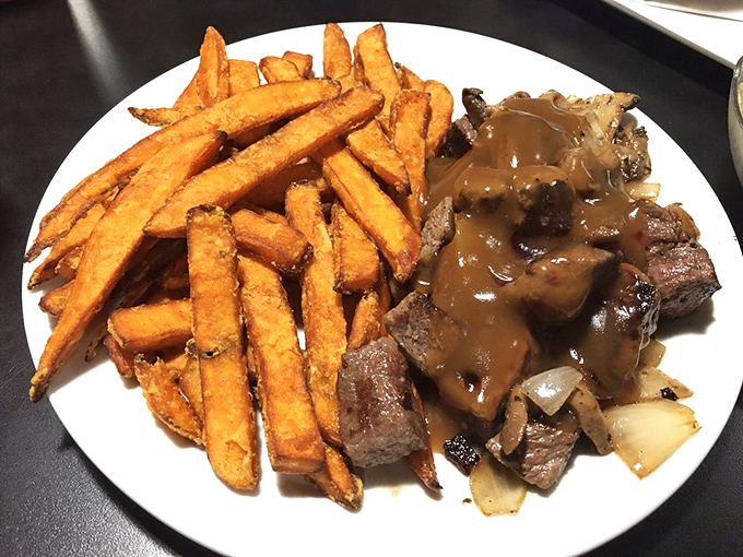 Steak and sweet potato fries &ndash; proof that diners do dinner just as well as breakfast. That gravy doesn't just cover the meat; it embraces it.