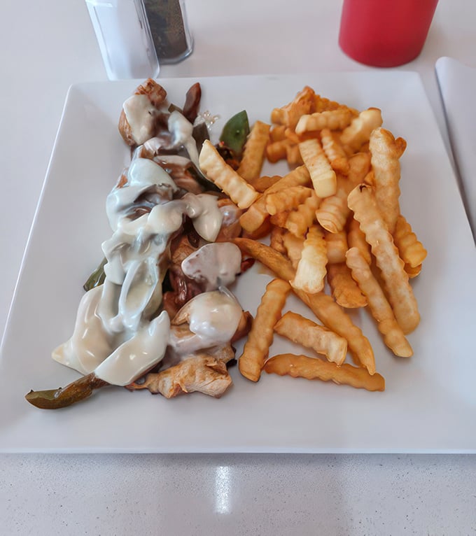 Philly chicken with a side of crispy, golden fries. It's like Philadelphia sent Illinois a delicious postcard saying, "Wish you were eating this!"