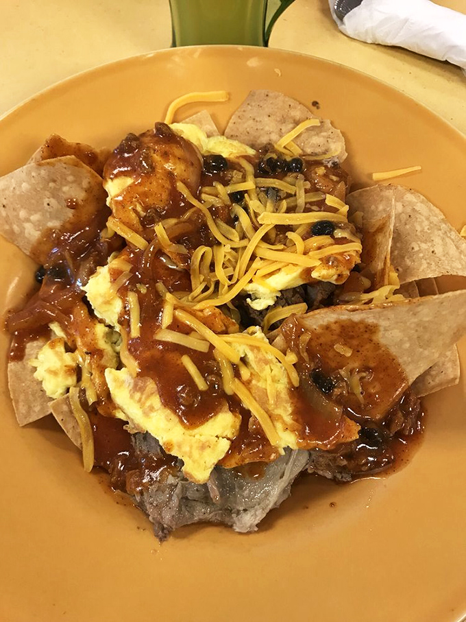 Pork chilaquiles: Where breakfast meets fiesta! It's like a pi&ntilde;ata exploded on your plate, but with less candy and more savory goodness.