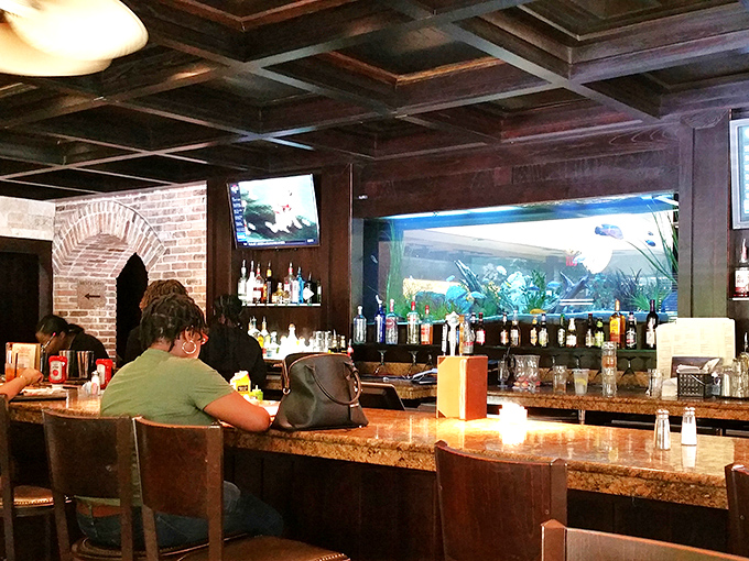 The bar area combines rustic charm with modern amenities—including what appears to be an aquarium. Fish watching you drink is the ultimate power move.