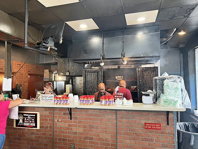 Behind this counter, pit masters work their magic while the brick walls hold decades of smoky secrets.