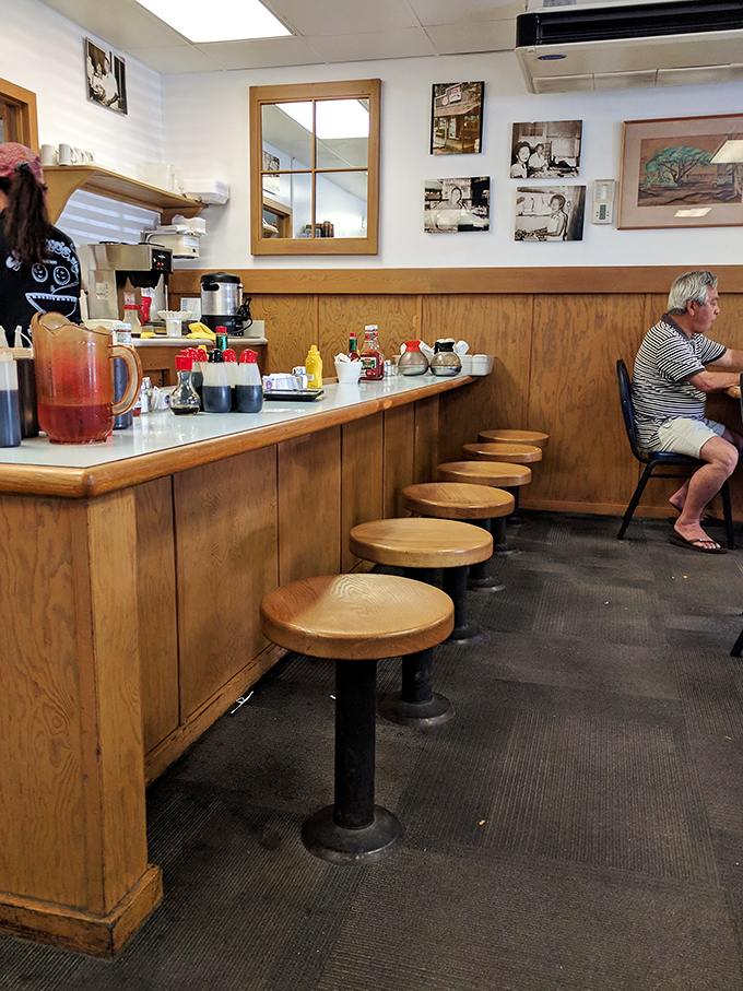 The counter where regulars have claimed their territory for decades. That pitcher of iced tea has probably witnessed more local gossip than a barber shop.
