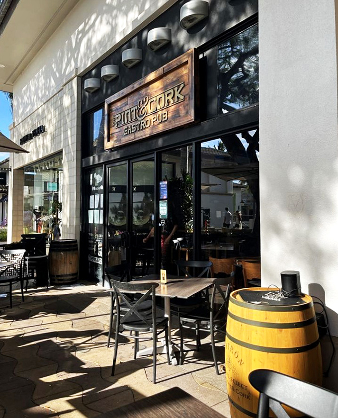 Sun-dappled outdoor seating with a charming barrel table transforms shopping center dining into something approaching European caf&eacute; culture.
