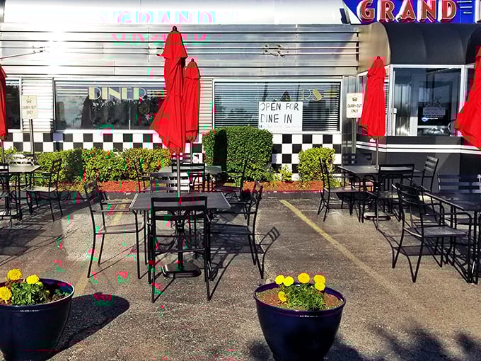 The outdoor seating area proves that even classic diners can embrace al fresco dining. Those red umbrellas and cheerful planters make summer breakfasts feel like mini-vacations.