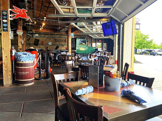 The garage doors roll up to create indoor-outdoor dining where blue shop towels serve as napkins and conversation flows as freely as the drinks.