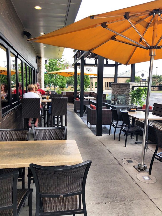 The patio: Where vitamin D meets vitamin "delicious" under cheerful orange umbrellas that match your summertime optimism.