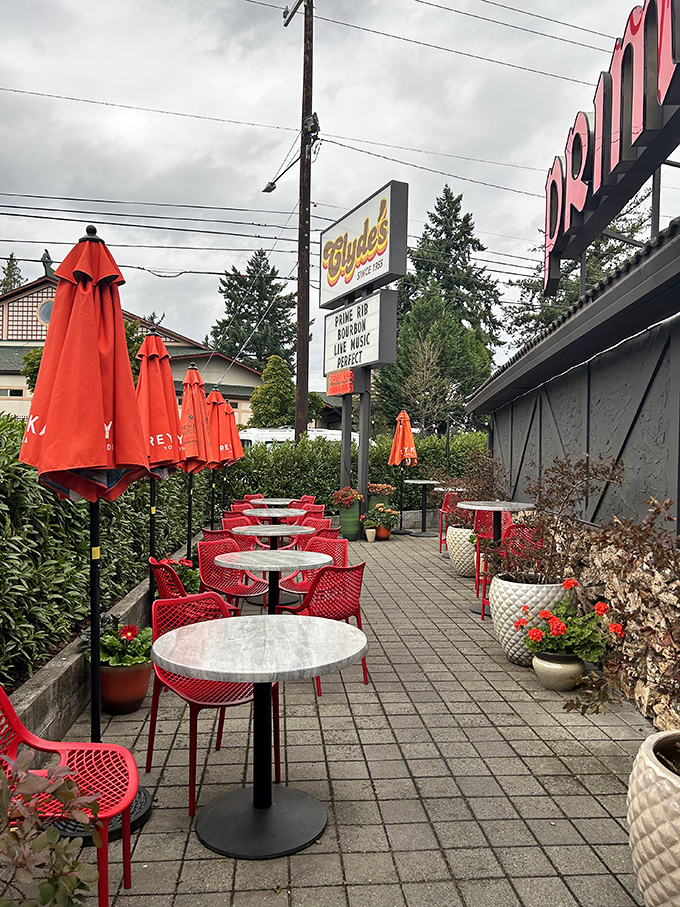 Al fresco dining, Portland style! Red umbrellas stand guard over tables, ready to shield you from rain or shine.