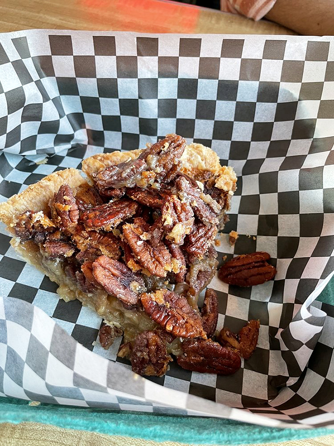 Pecan see clearly now! This slice of pecan pie is a nutty nirvana, with its gooey filling and perfectly toasted pecans piled high.
