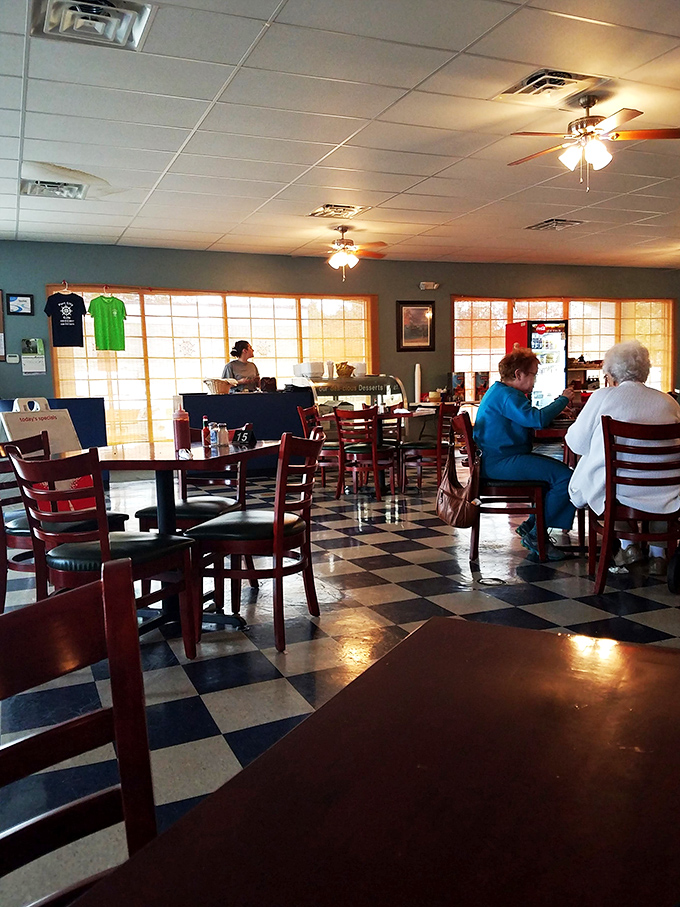 Sunlight streams in, illuminating a sea of red chairs. It's like Edward Hopper's "Nighthawks," but with more pancakes and smiles.