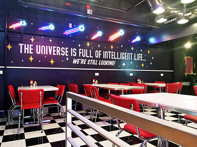 Cosmic diner vibes! With a wall mural like that, you'll be pondering life's big questions while munching on your burger.