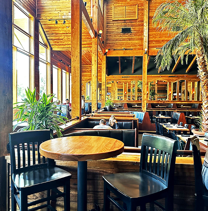 Wooden tables await beneath soaring ceilings, each setting a stage where memorable meals and conversations will unfold.