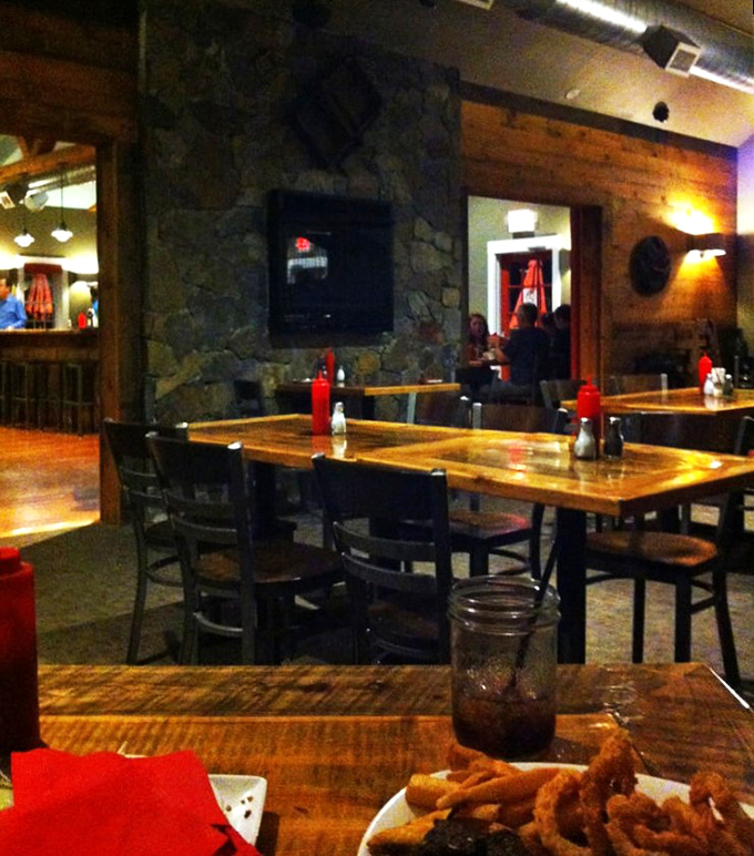 Stone walls and wooden tables create dining nooks that feel like you've discovered a secret meat society's cozy headquarters.