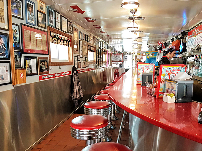 A gallery of memories on the wall. Each photo and memento tells a story, making this diner a living museum of Manchester's history.